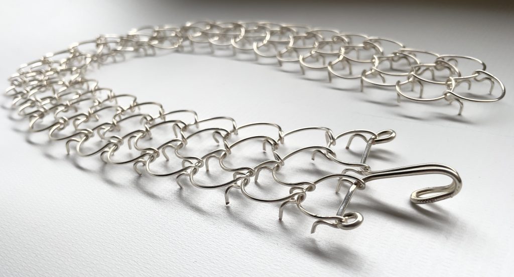 A three link, 1mm gauge full-length waist metal cilice with metal ...